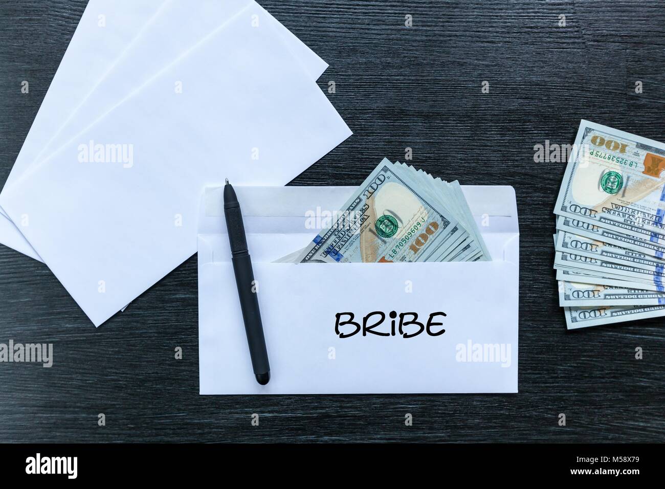Bribe in an envelope Stock Photo - Alamy