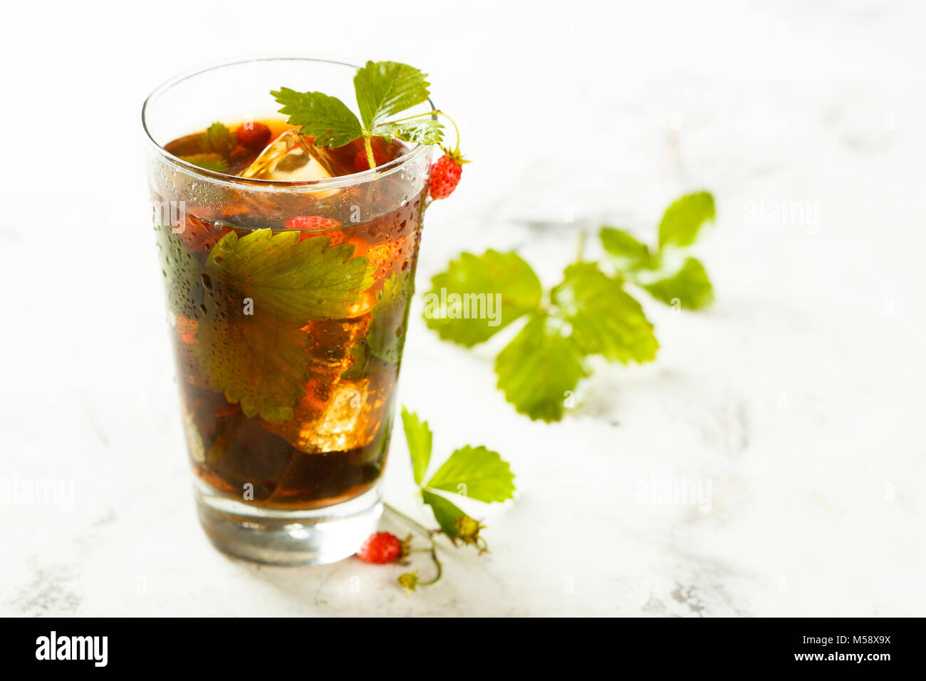 Refreshing iced tea with wild strawberry Stock Photo - Alamy