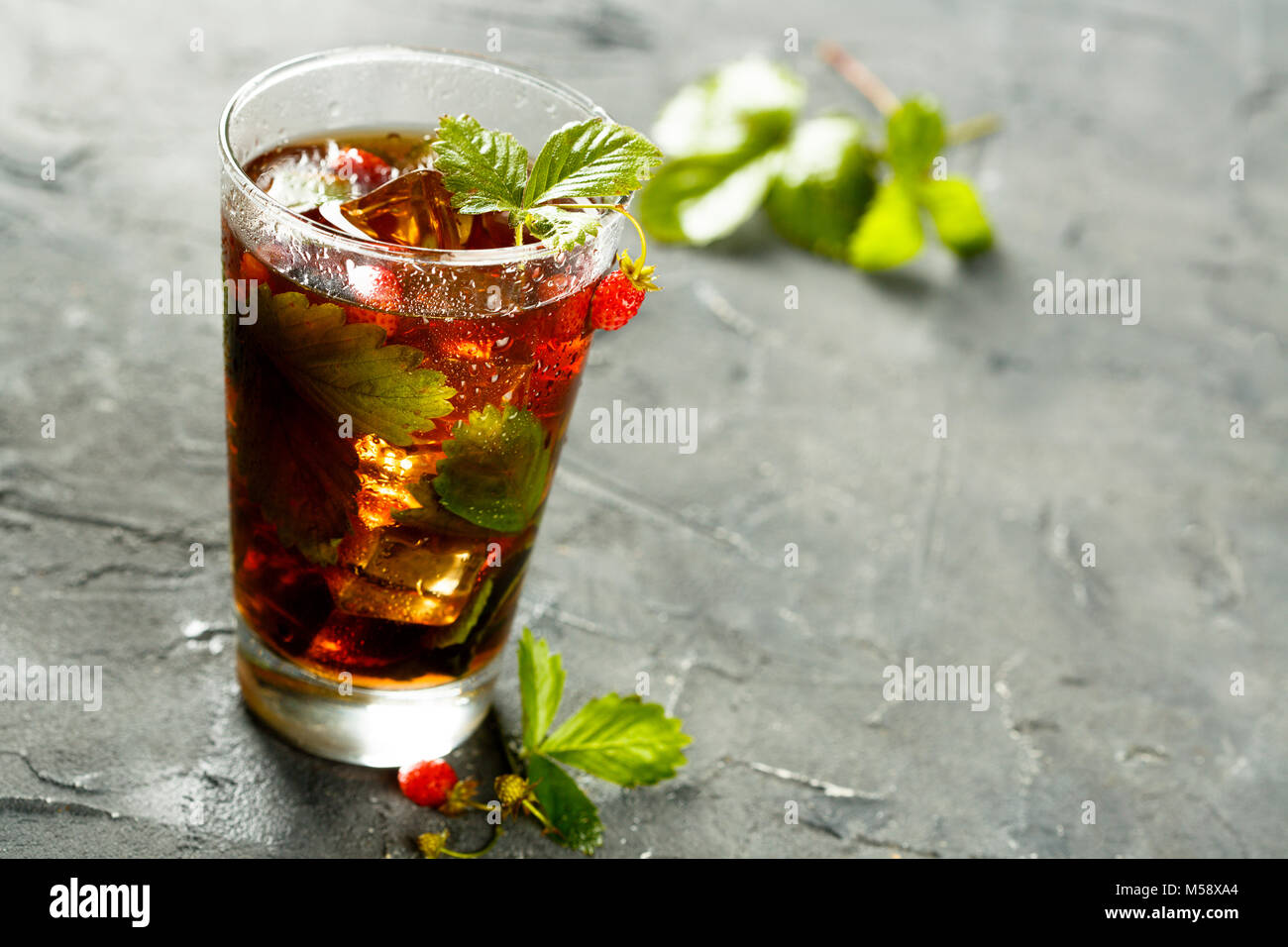 Refreshing iced tea with wild strawberry Stock Photo - Alamy