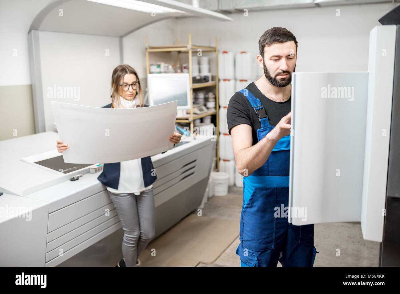 Woman with print operator at the manufacturing Stock Photo - Alamy