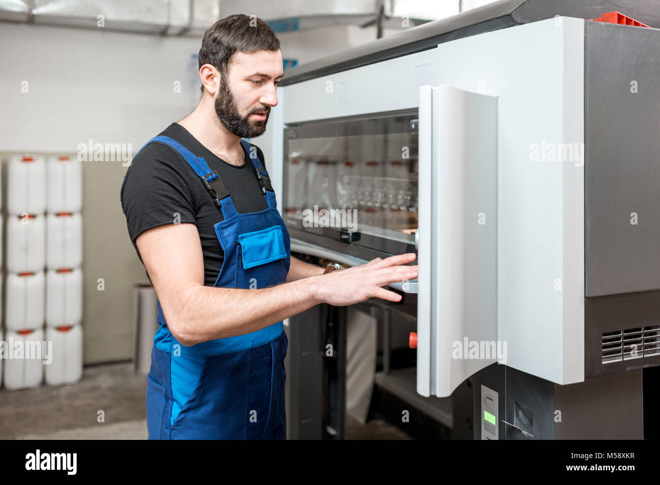 Printing operator working at the manufacturing Stock Photo - Alamy