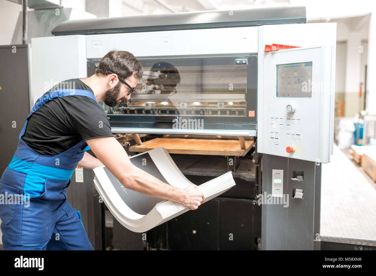 Man working with printing machine at the manufacturing Stock Photo - Alamy