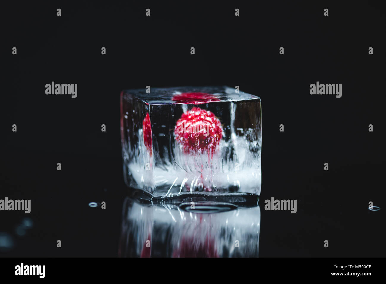 raspberry frozen in ice cube Stock Photo - Alamy