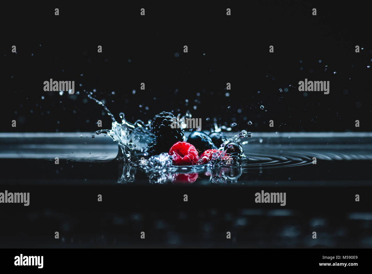 Raspberries water splashing hi-res stock photography and images - Alamy