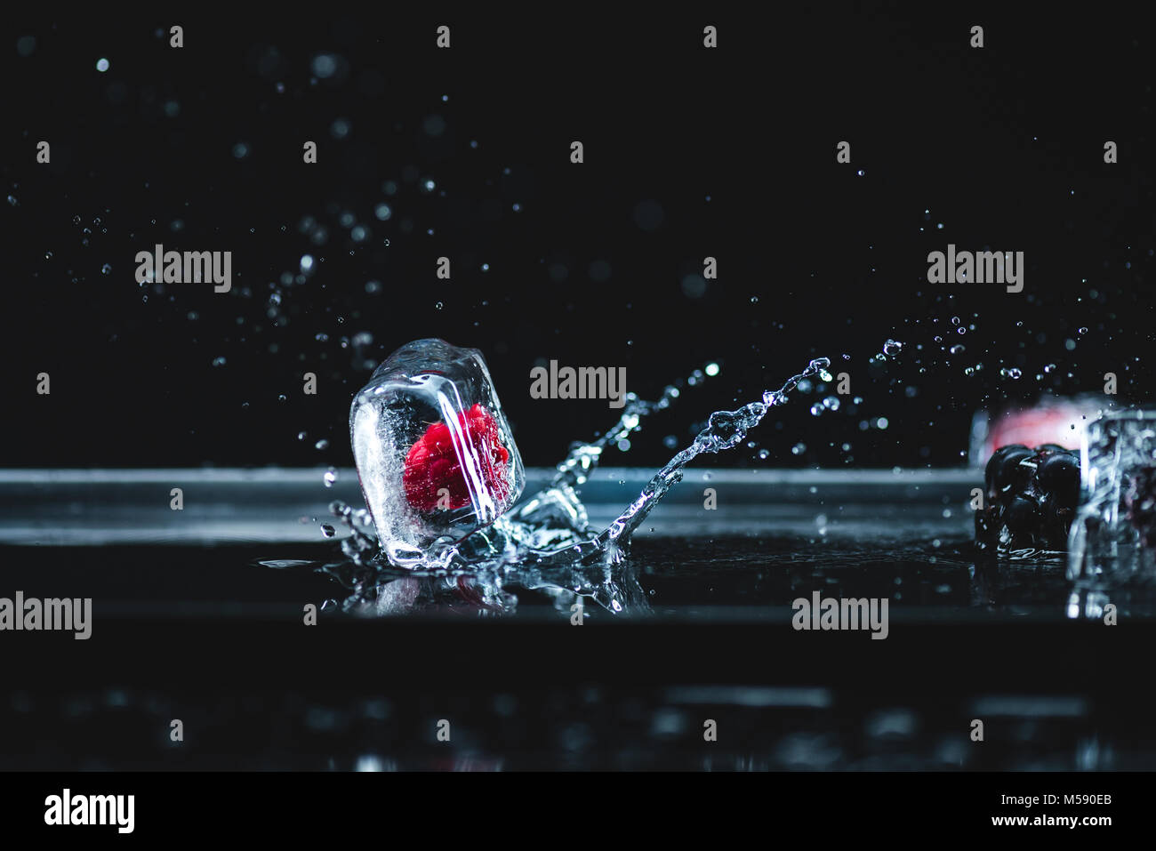 raspberry frozen in ice cube Stock Photo - Alamy