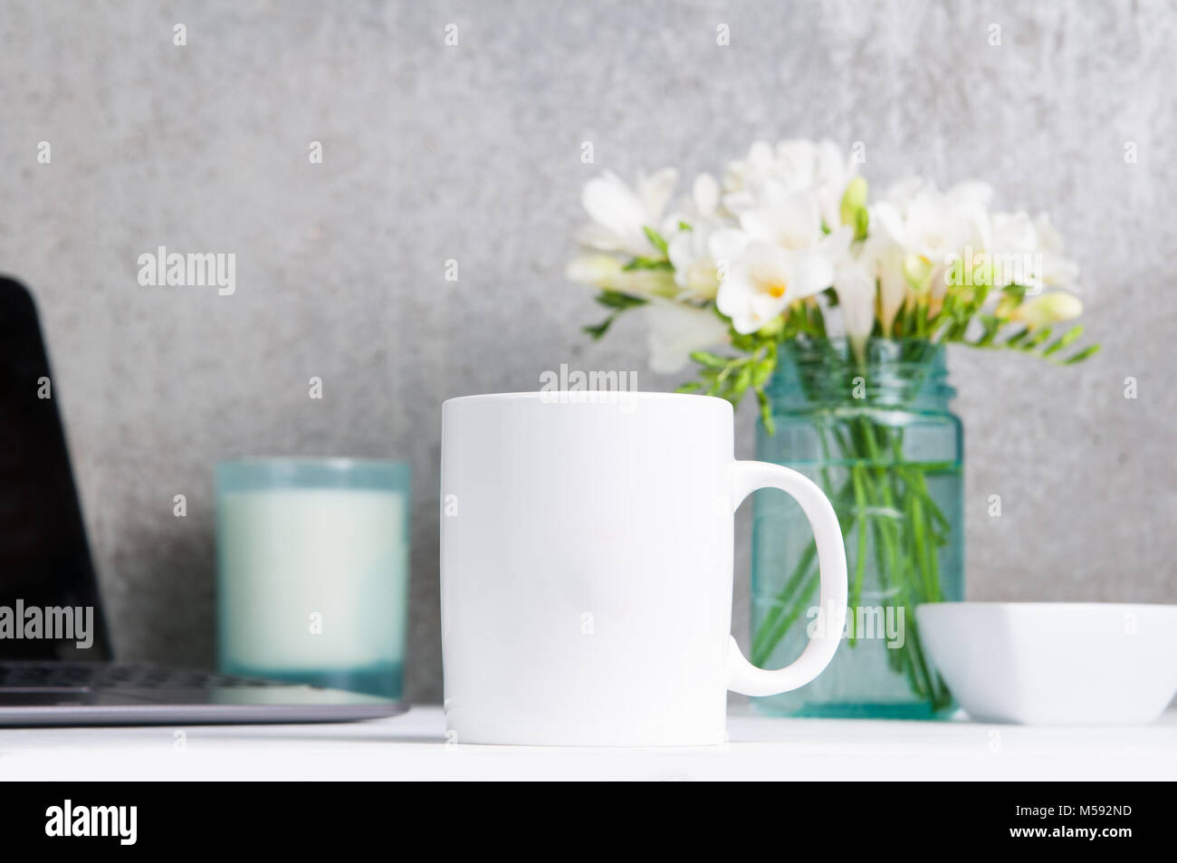 desk top with computer mug and flowers Stock Photo - Alamy