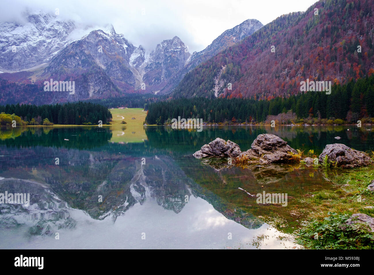 Beautiful Lago di Fusine mountain lake in autumn and Mangart mountain ...