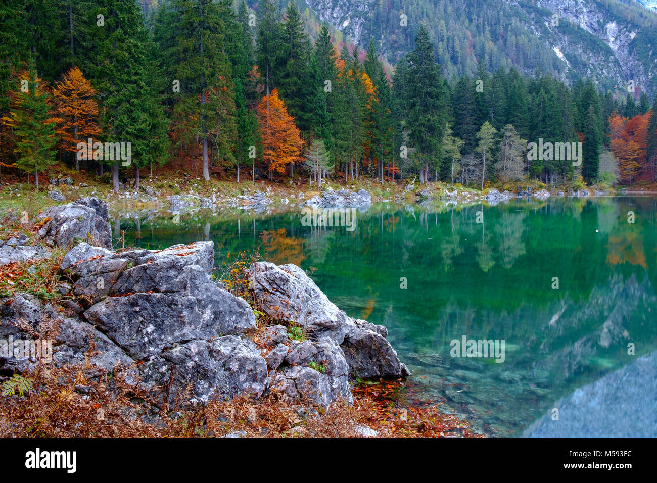 Beautiful Lago di Fusine mountain lake in autumn and Mangart mountain ...
