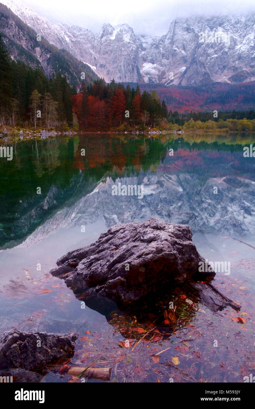 Beautiful Lago di Fusine mountain lake in autumn and Mangart mountain ...