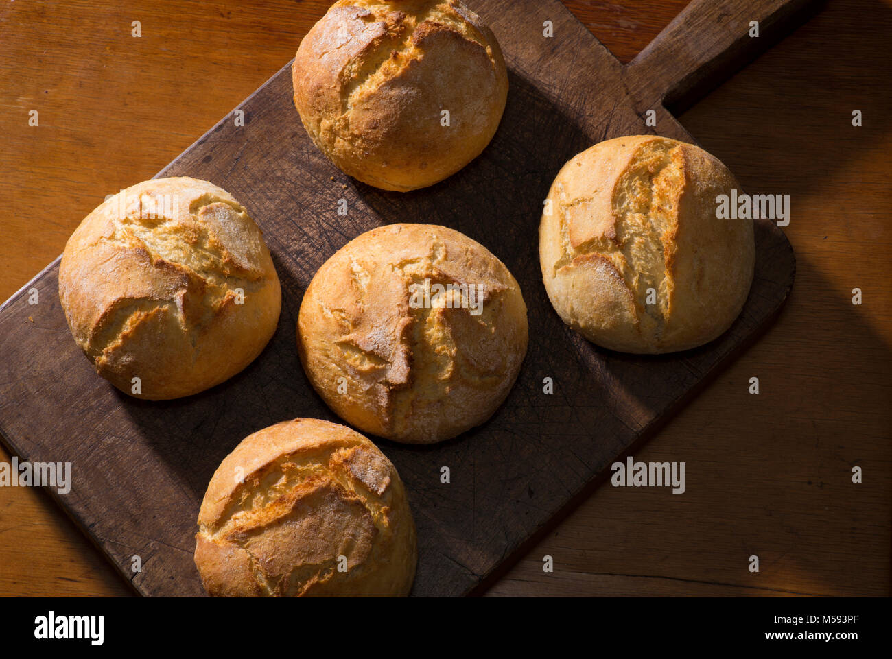 Traditional rustic buns on a vintage cutting board Stock Photo - Alamy