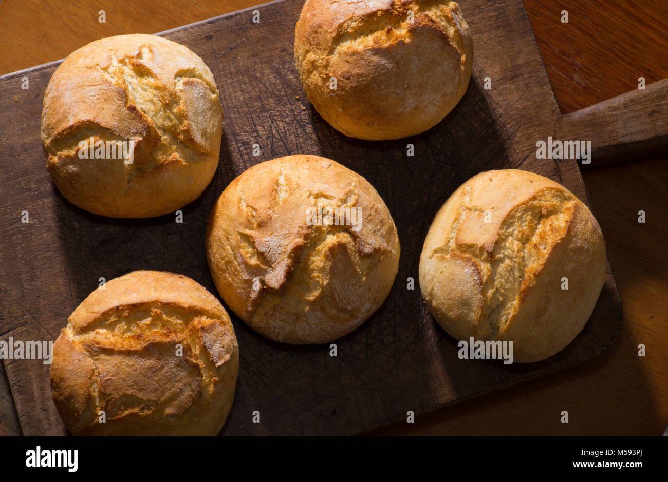 Traditional rustic buns on a vintage cutting board Stock Photo - Alamy