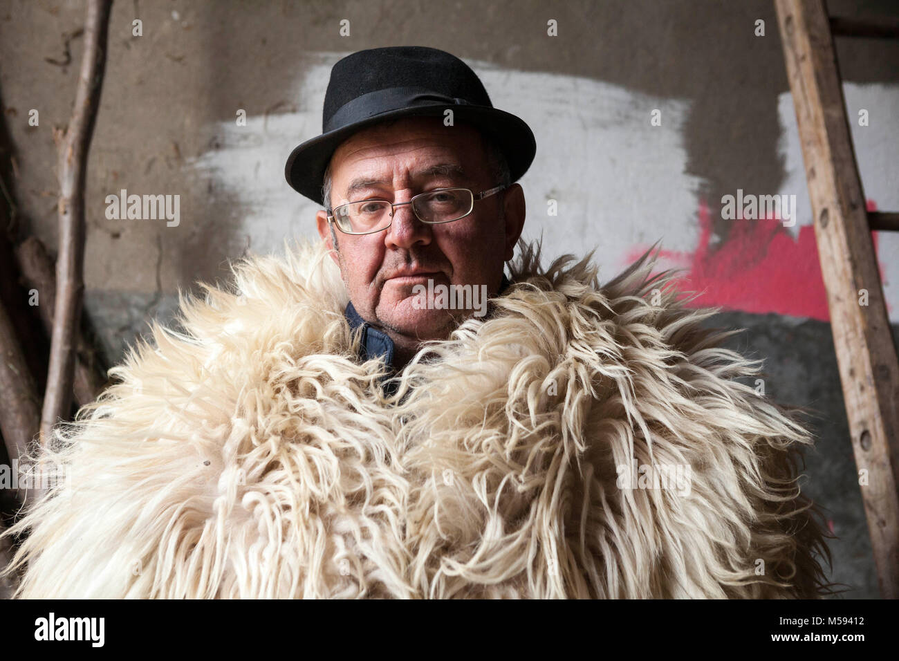 Romanian shepherd wearing a traditional coat made from sheep skins ...