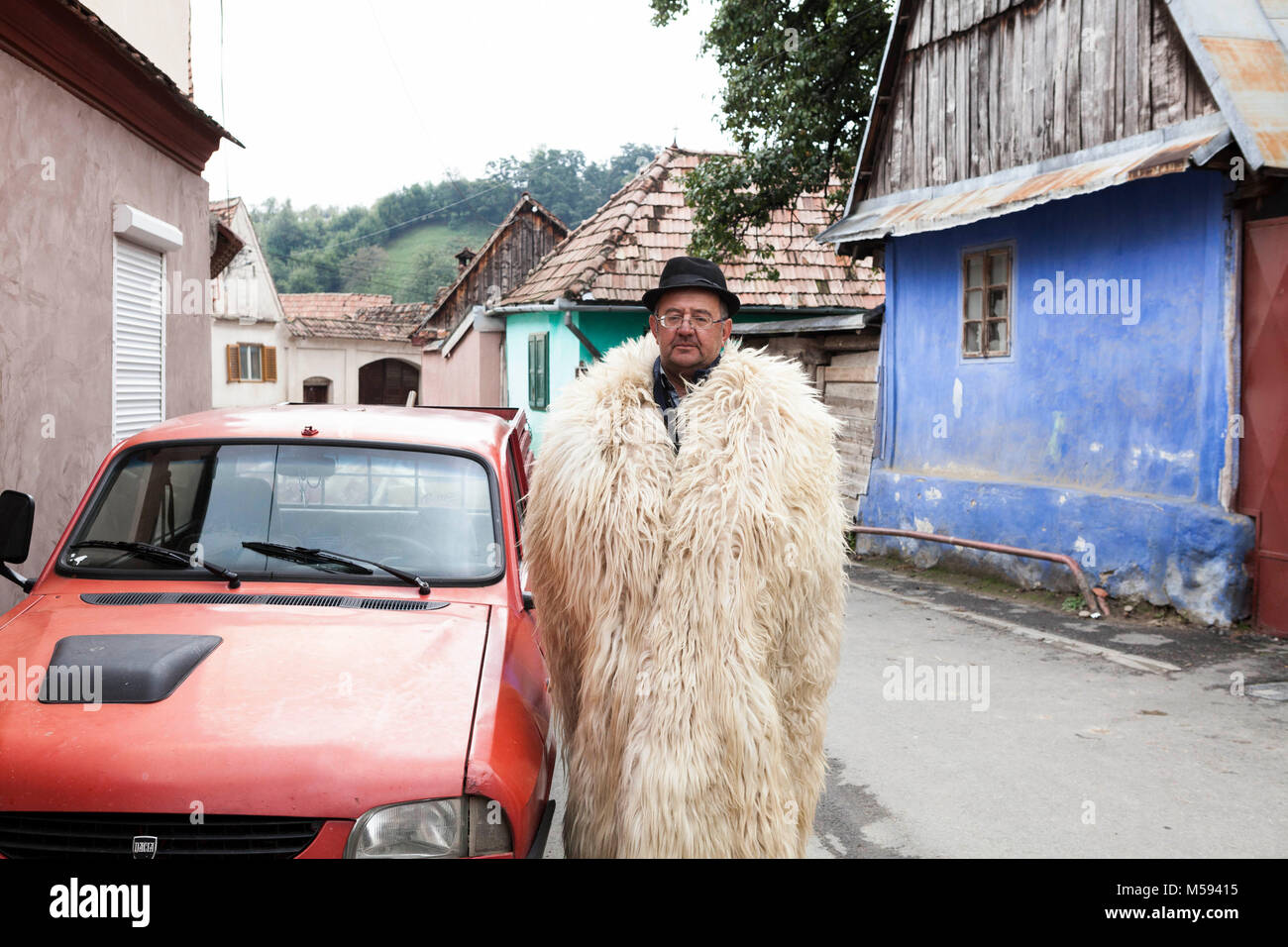 Romanian shepherd wearing a traditional coat made from sheep skins ...