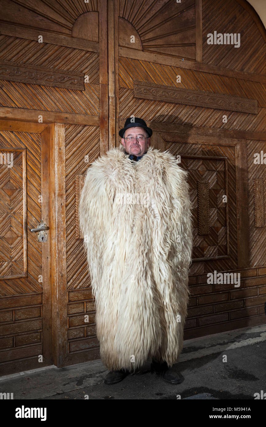 Romanian shepherd wearing a traditional coat made from sheep skins ...