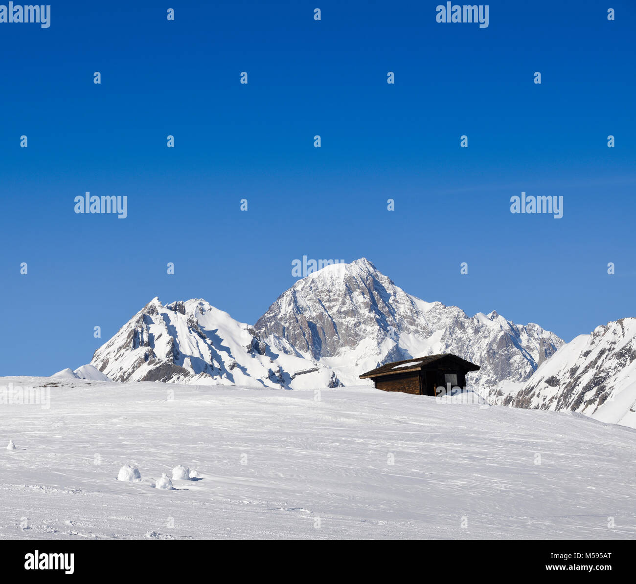 Wooden cabin in the Italian Alps during the winter, with copy space ...