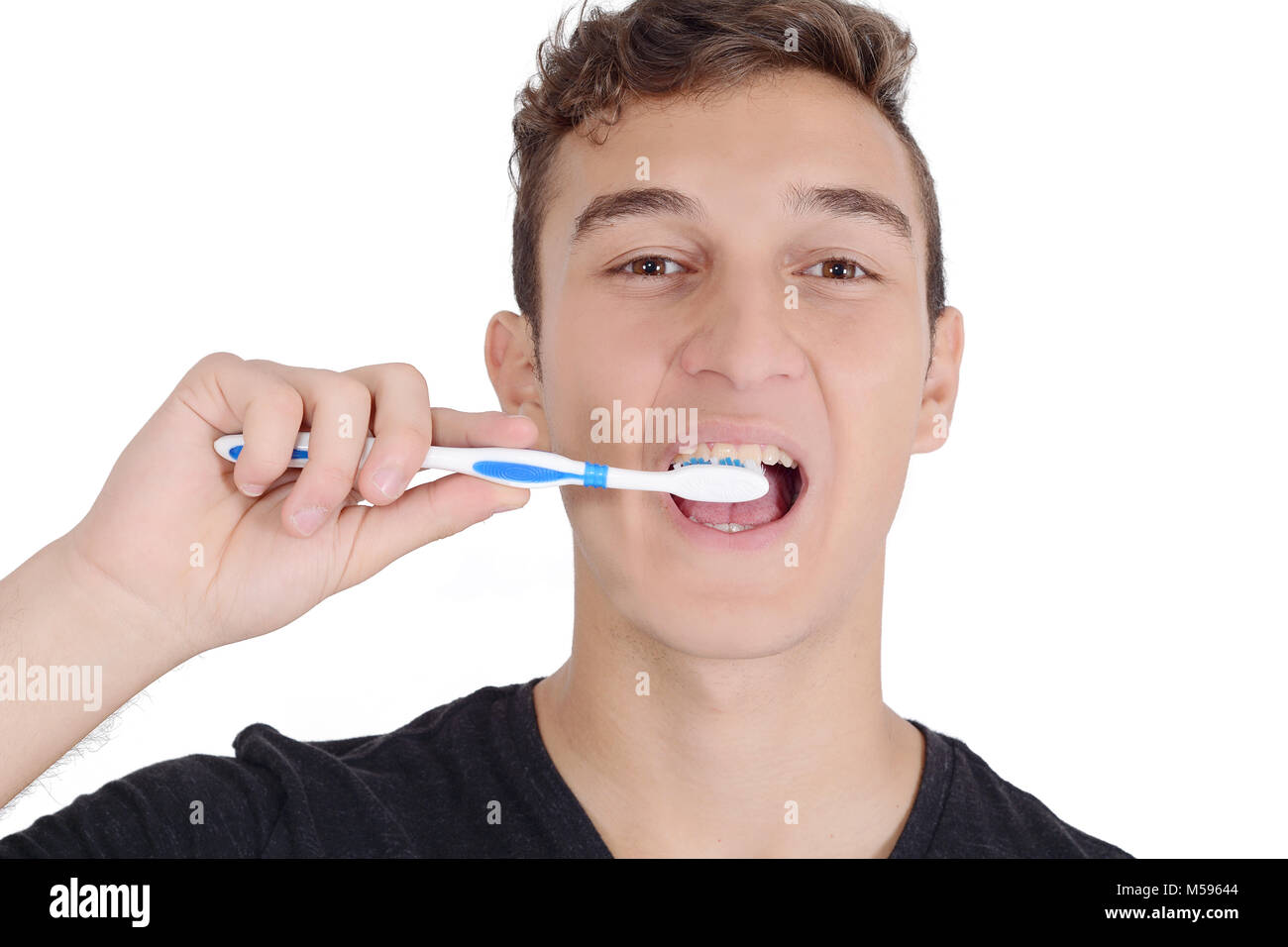 Close up of young man brushing his teeth. Health and beauty concept ...