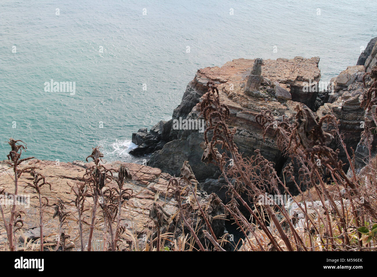 View of Sinseon Rock, rocky and steep cliff, ocean and grass as ...