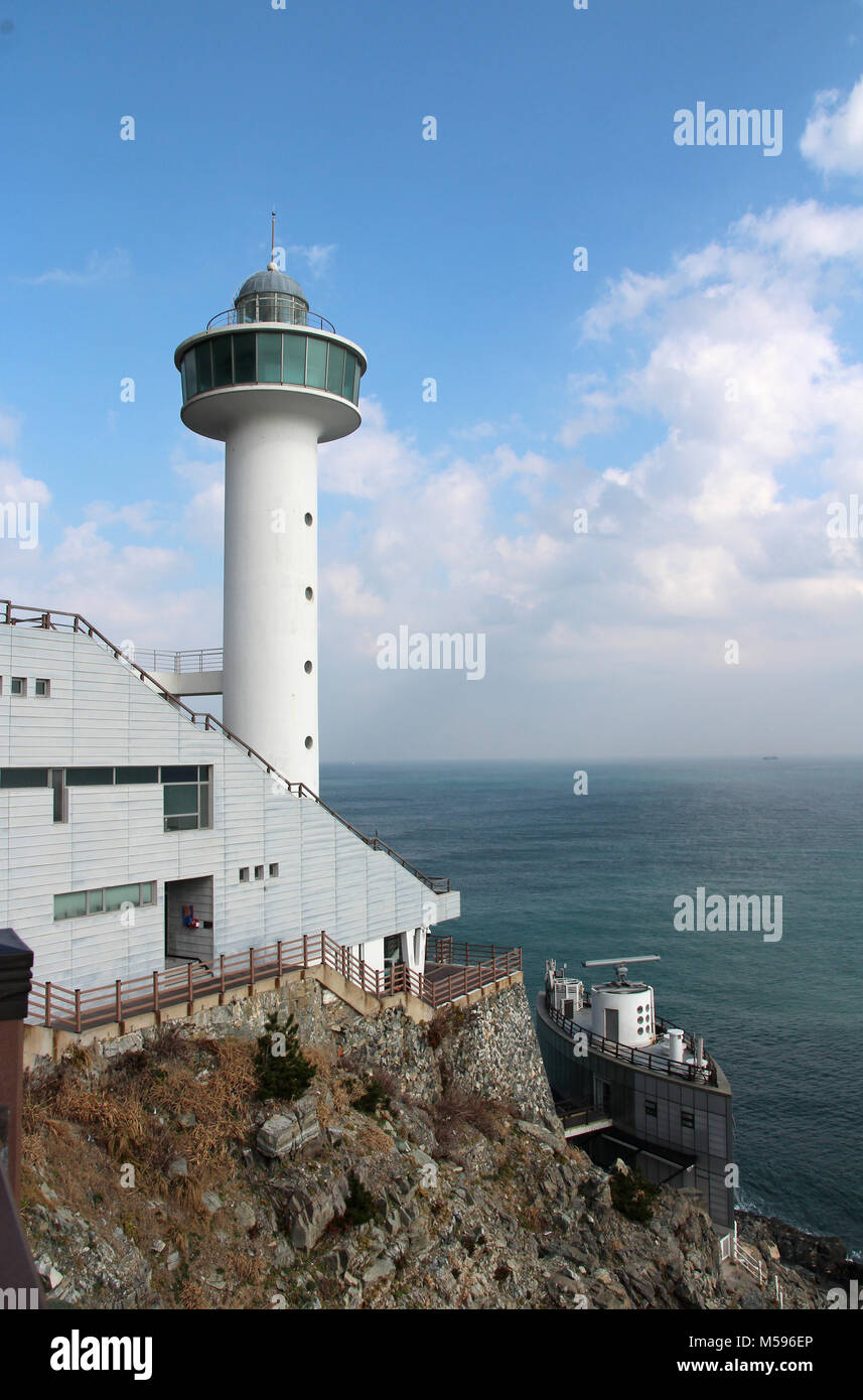 Yeongdo Lighthouse against the blue sea and sky at Taejongdae park ...