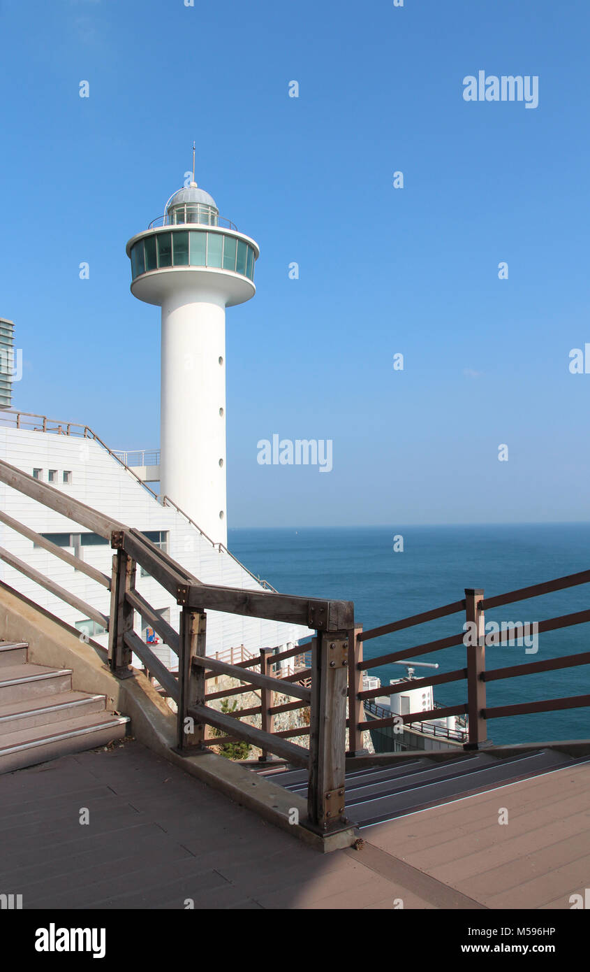 Yeongdo Lighthouse against the blue sea and sky at Taejongdae park ...