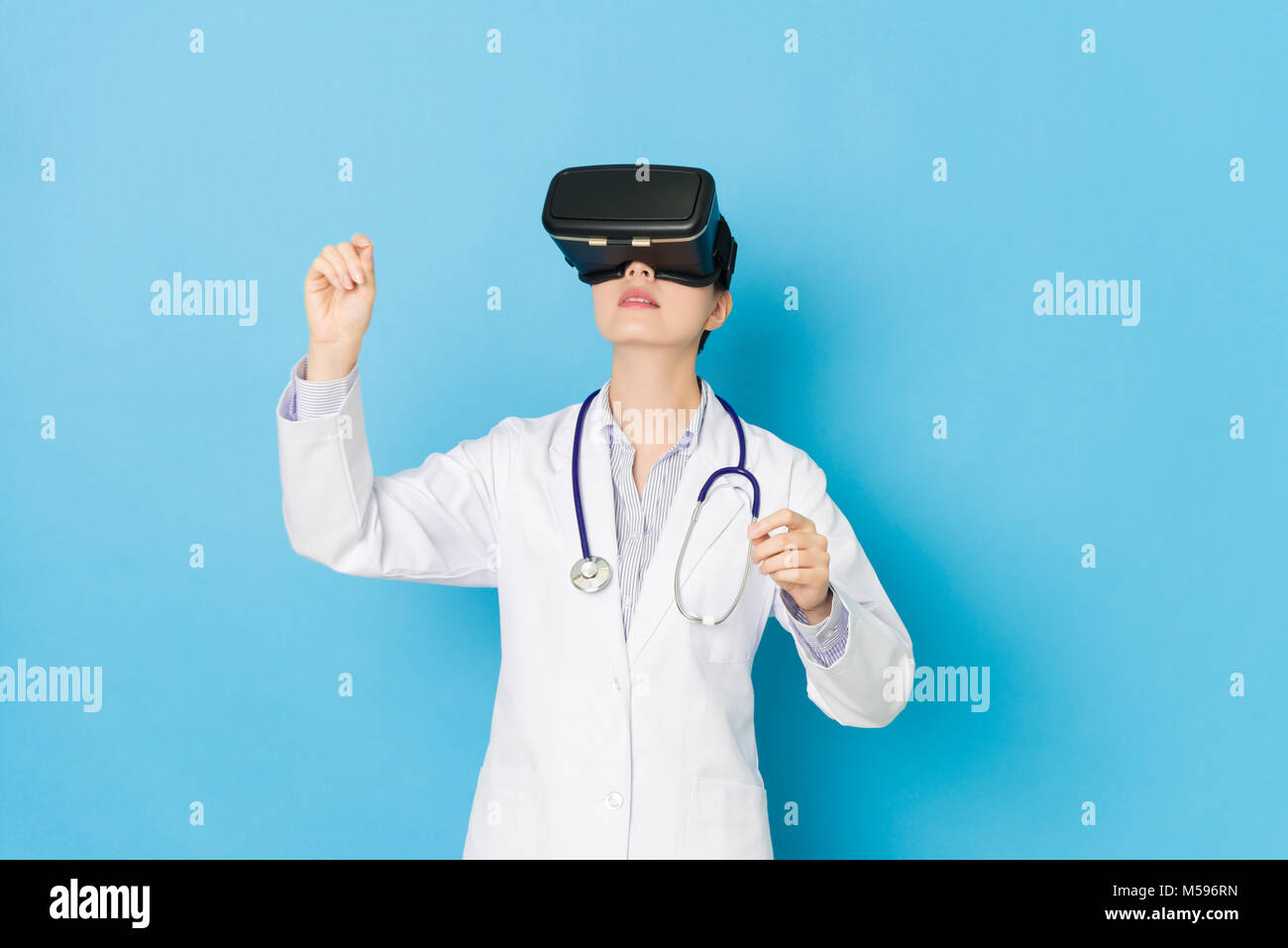 beautiful pretty hospital doctor woman wearing VR technology standing ...