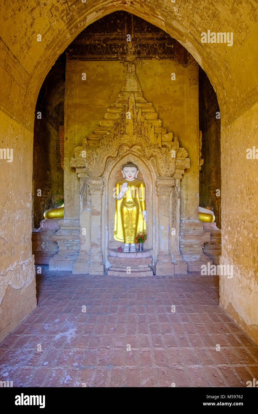 A golden Buddha statue in one of the pagodas of Bagan in the plains of ...