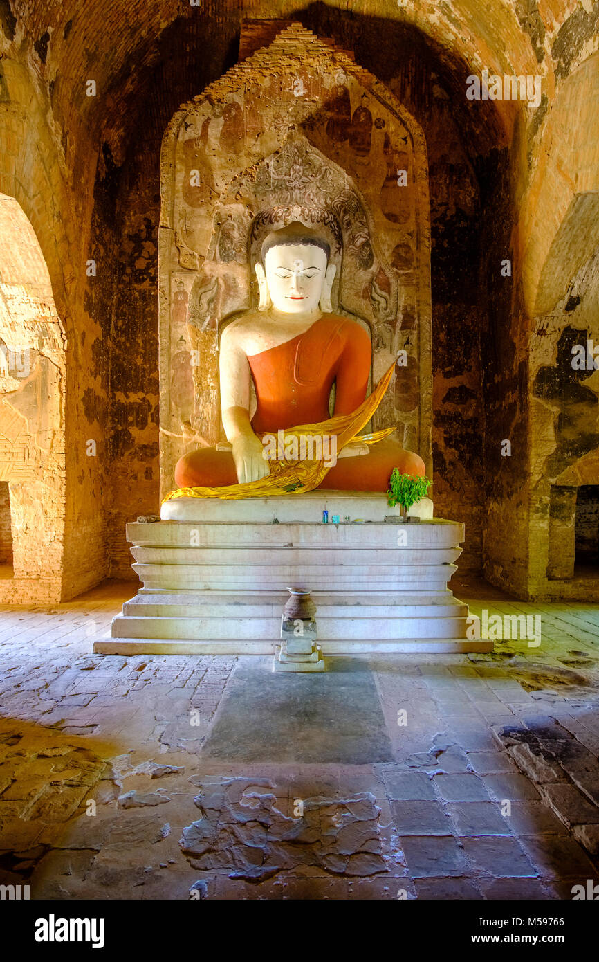 A Buddha statue in one of the pagodas of Bagan in the plains of the ...