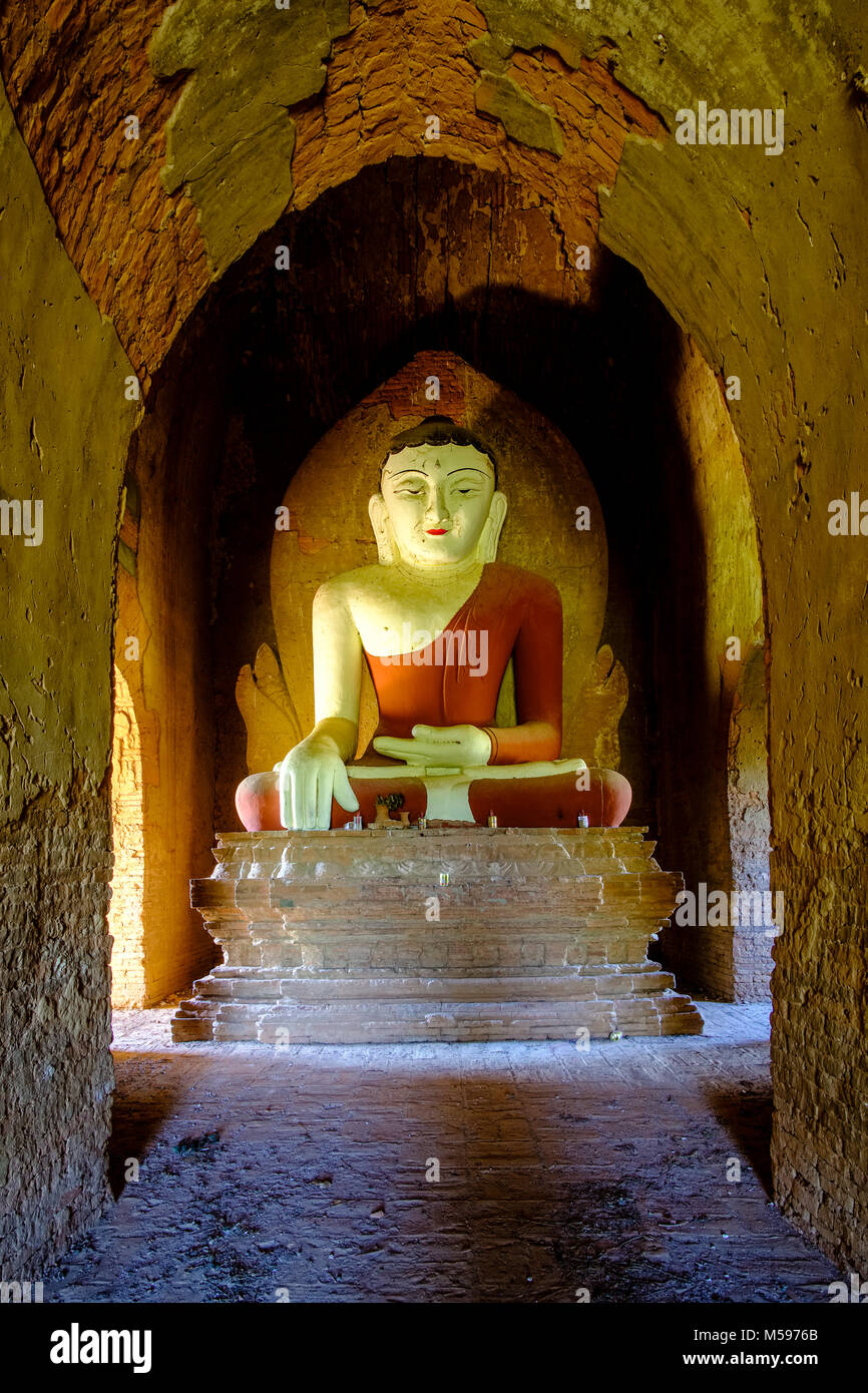 A Buddha statue in one of the pagodas of Bagan in the plains of the ...