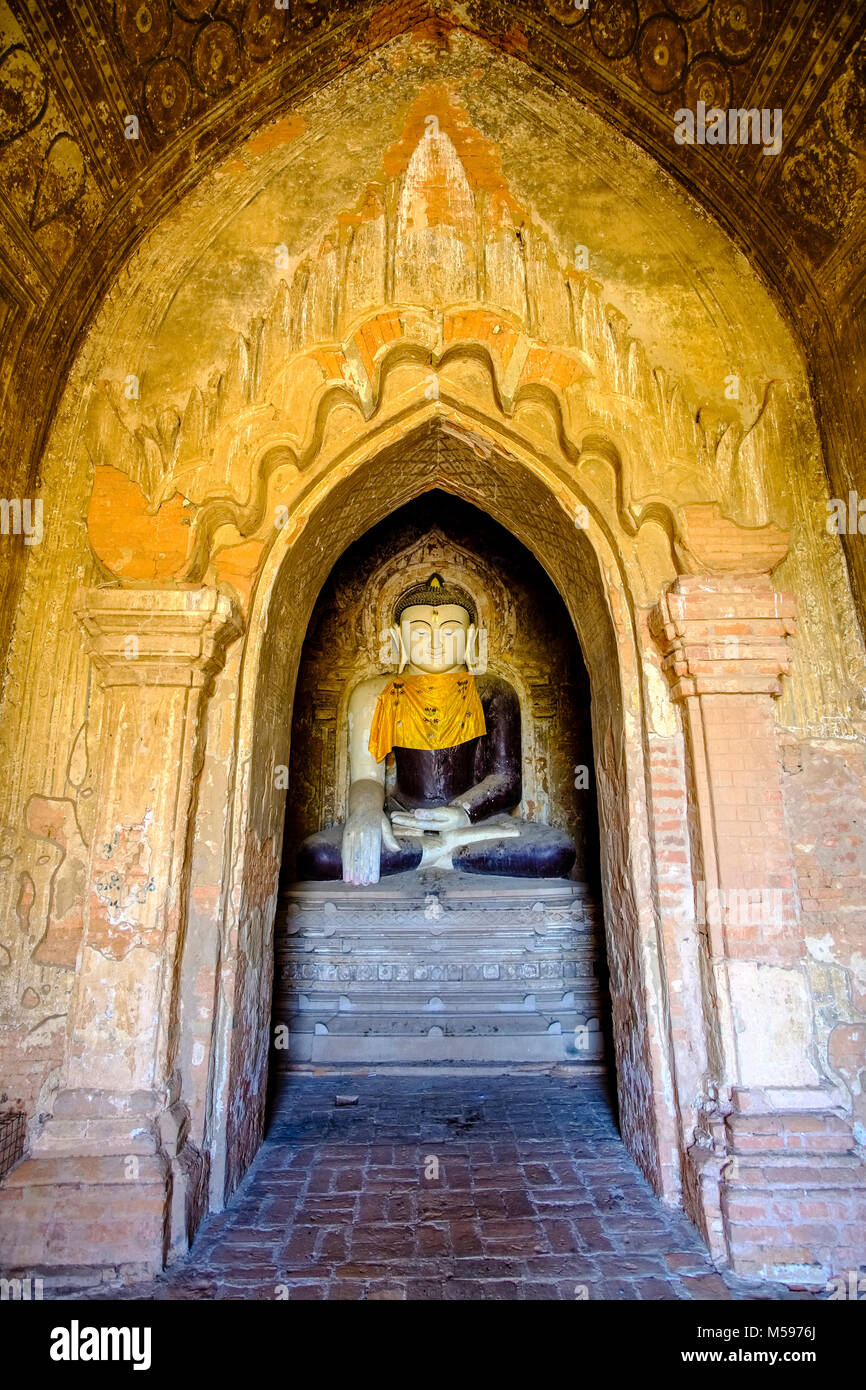 A Buddha statue in one of the pagodas of Bagan in the plains of the ...