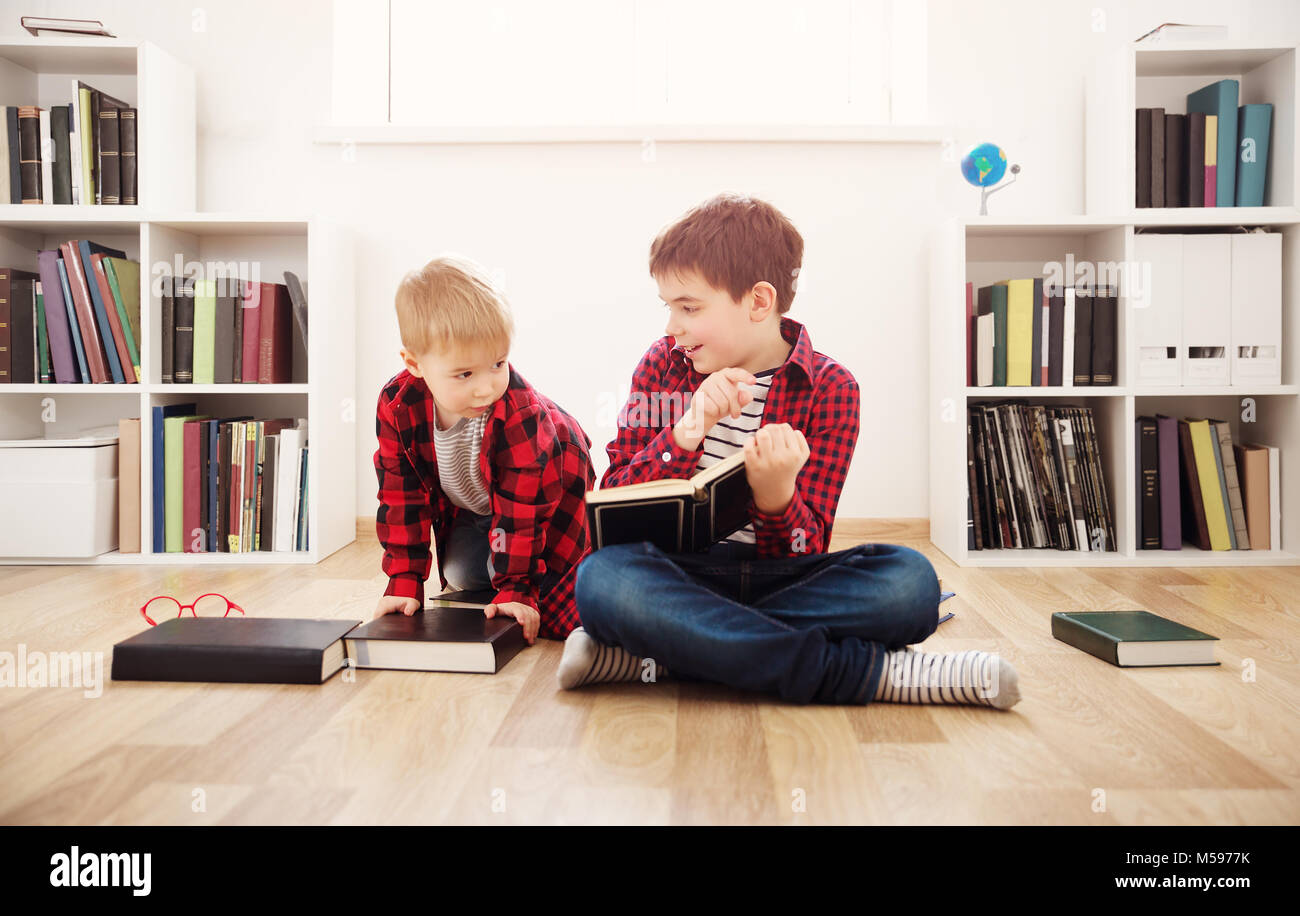 Three years old child sitting among books at home Stock Photo - Alamy
