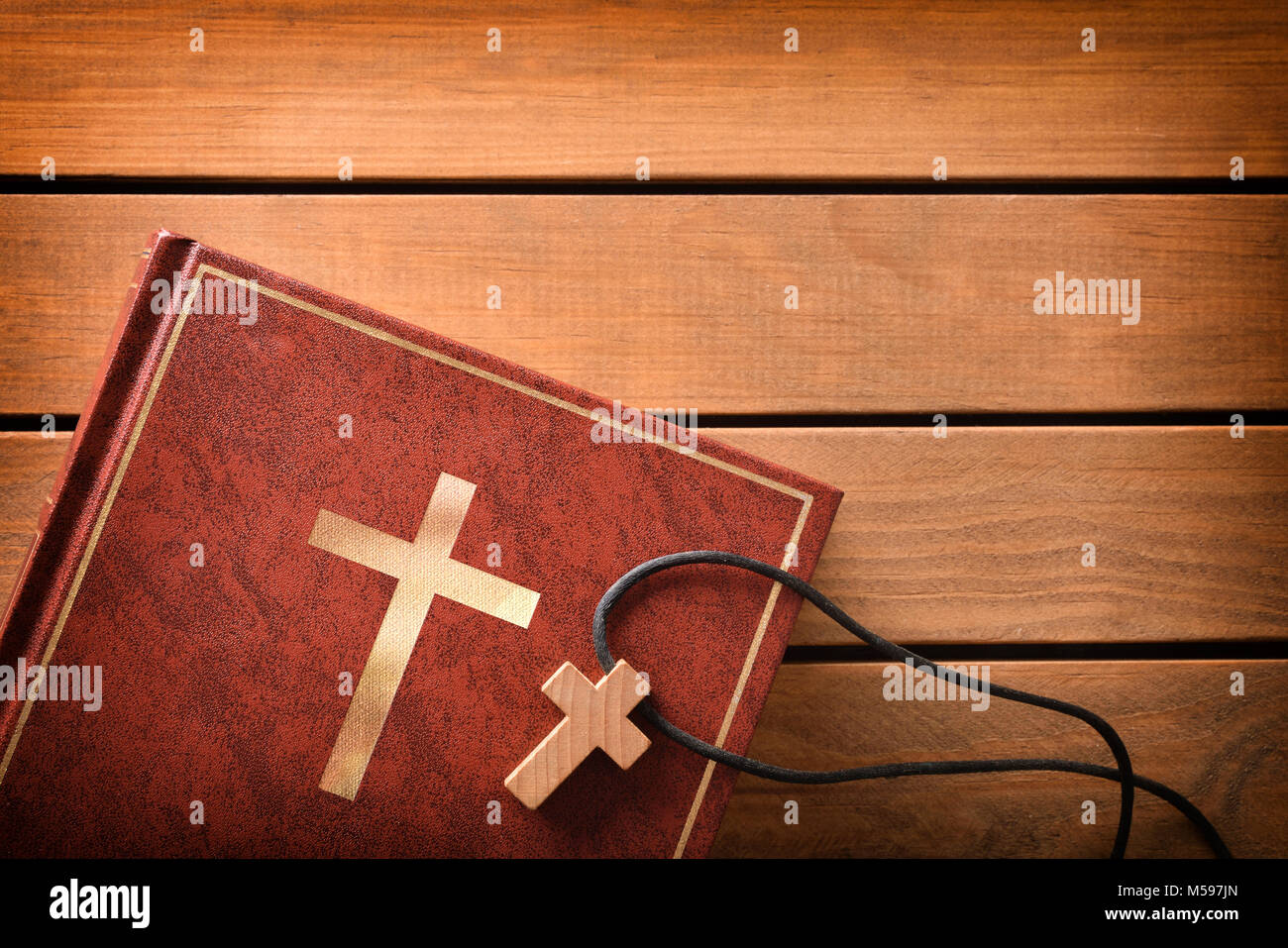 Brown leather cover of a Bible with cross-shaped wooden pendant on ...