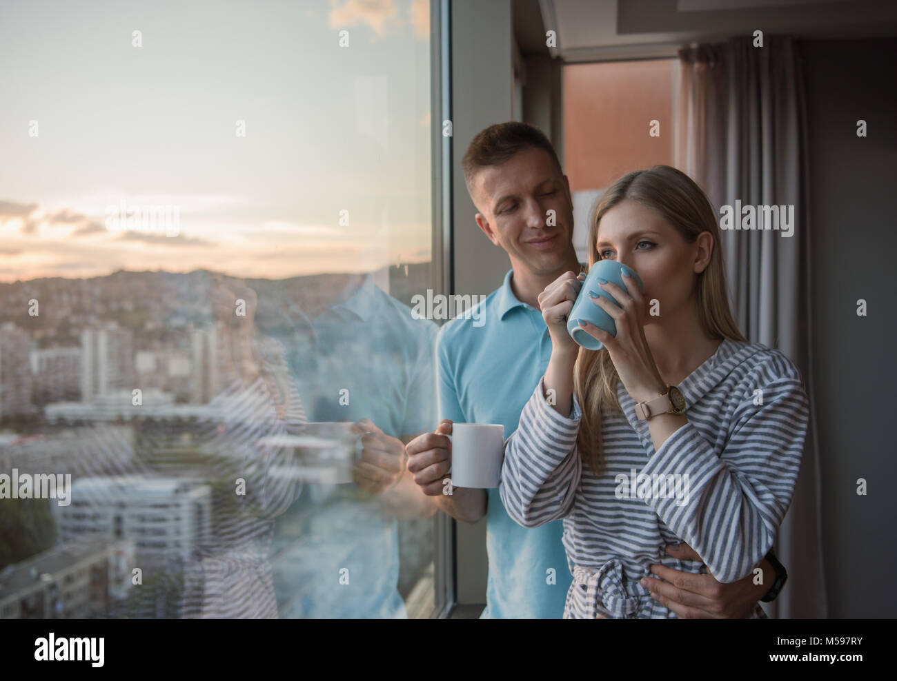 romantic happy young couple enjoying evening coffee and beautiful ...
