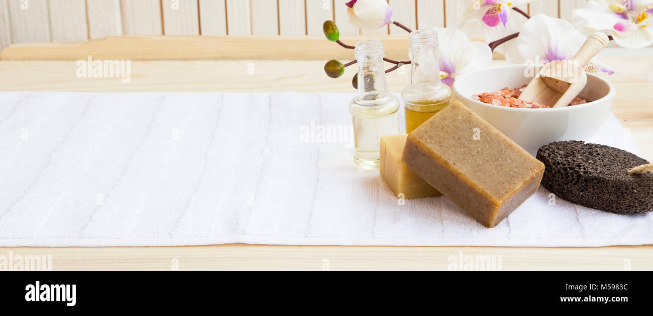 Spa setting still life with natural soaps,orchid flowers , bath oil ...