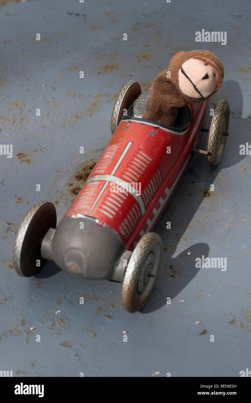Cute monkey finger puppet sitting in a vintage toy car Stock Photo - Alamy