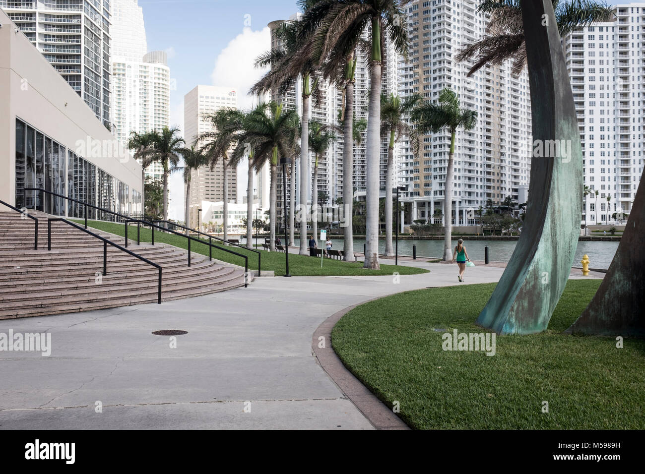 Woman walking along waterfront path in downtown Brickell, Miami ...