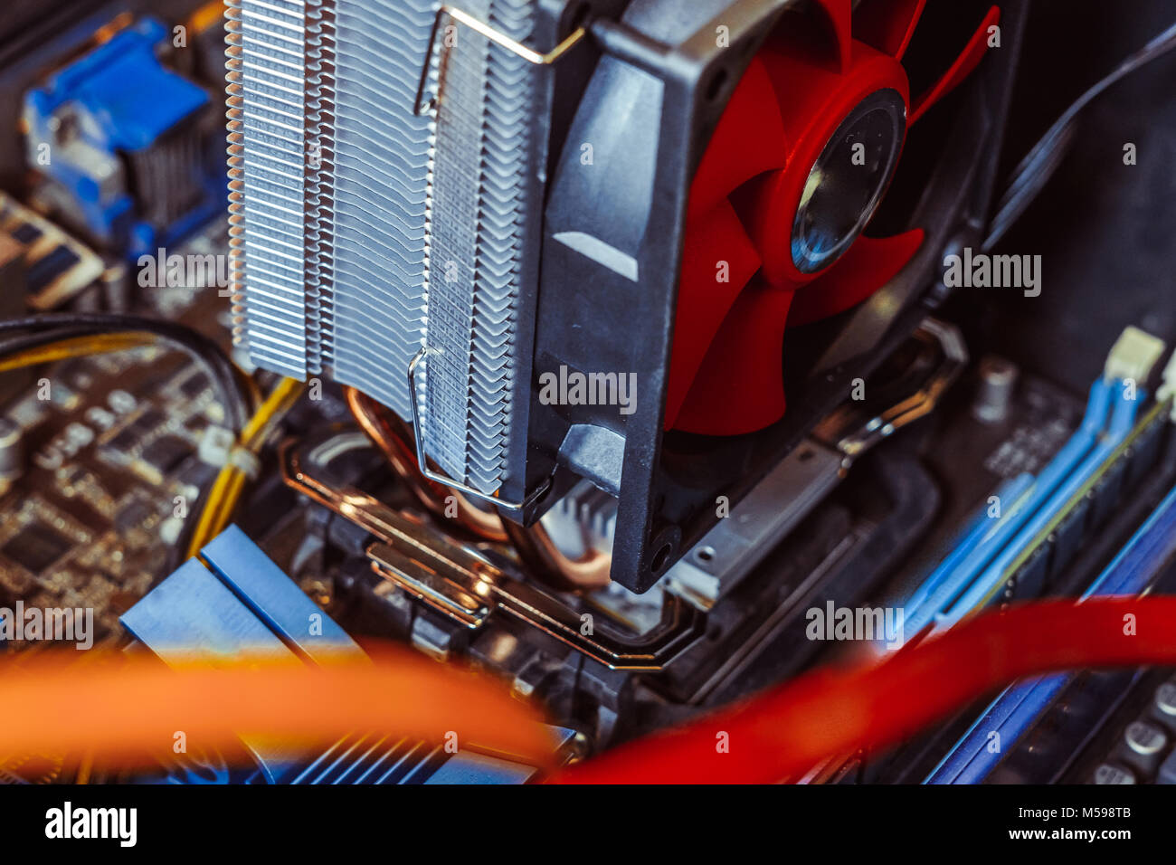 Dust on the computer pc processor cooler with mainboard and computer case fragment. Selective ...