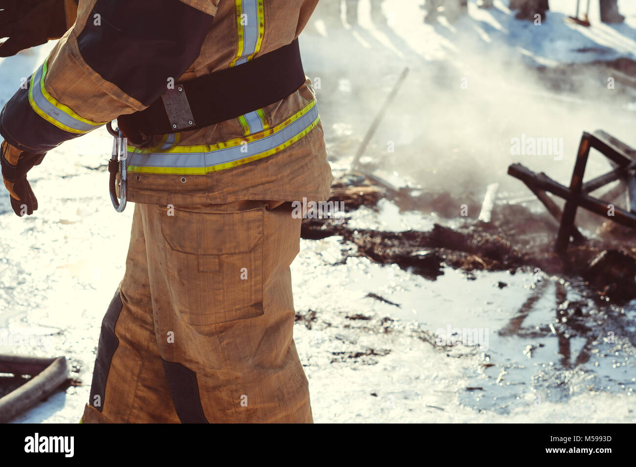 firefighter extinguishes with water Stock Photo - Alamy