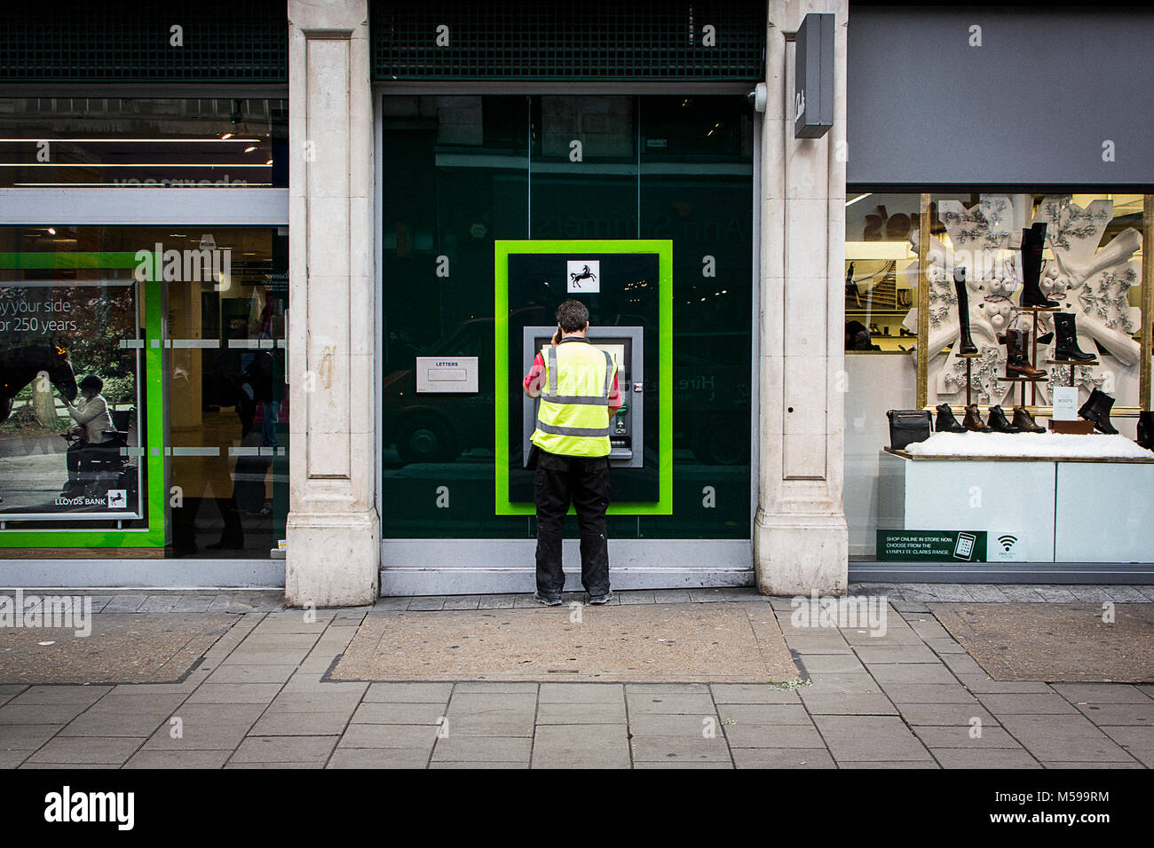 Man withdrawing money from ATM Stock Photo - Alamy