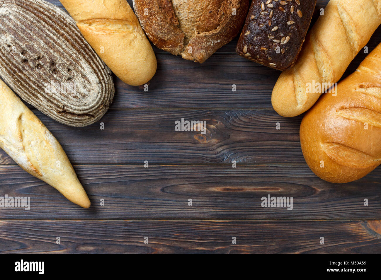 Bakery background, bread assortment on black wooden backdrop. Top view ...