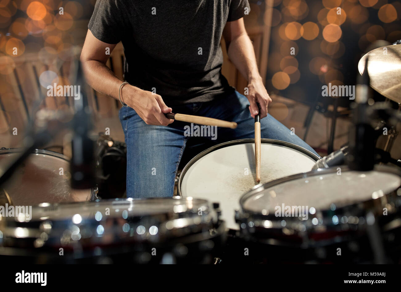 musician playing drum kit at concert over lights Stock Photo - Alamy