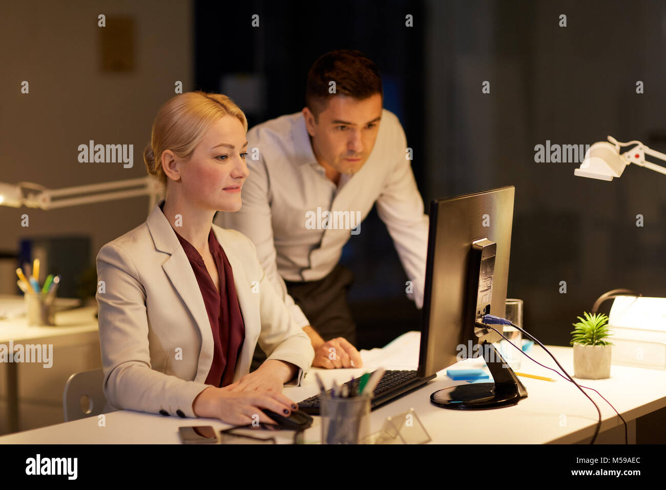 business team with computer working late at office Stock Photo - Alamy