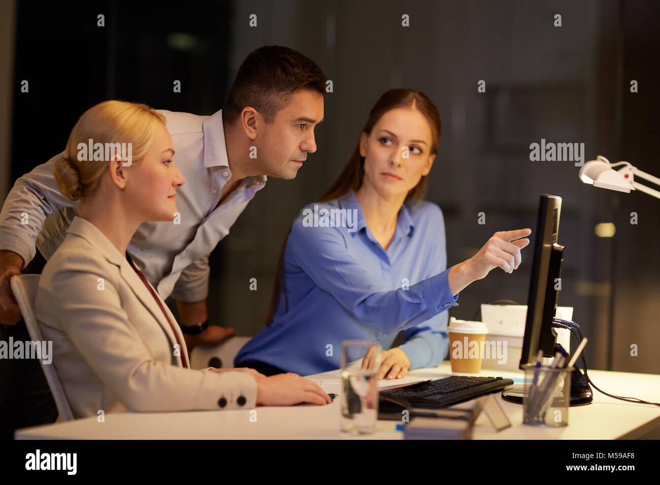 business team with computer working late at office Stock Photo - Alamy