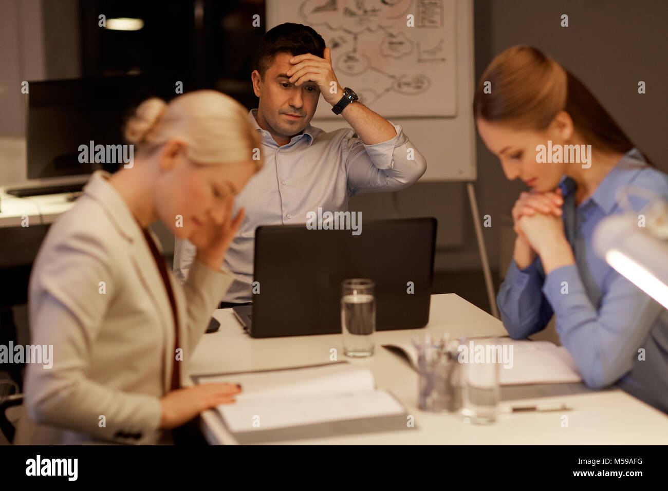 business team with laptop working late at office Stock Photo - Alamy