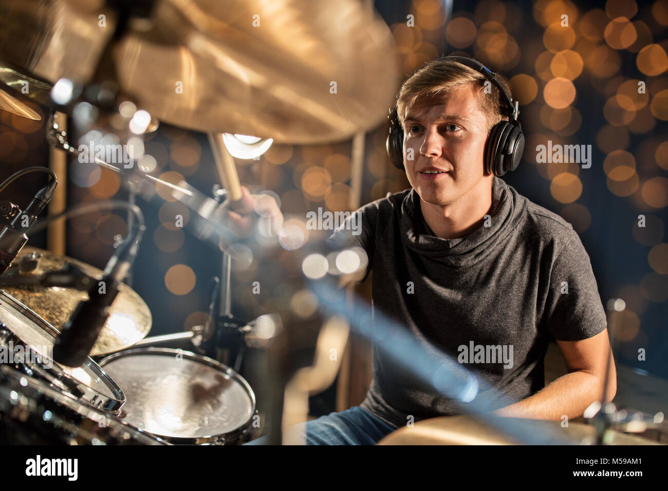 musician playing drum kit at concert over lights Stock Photo - Alamy