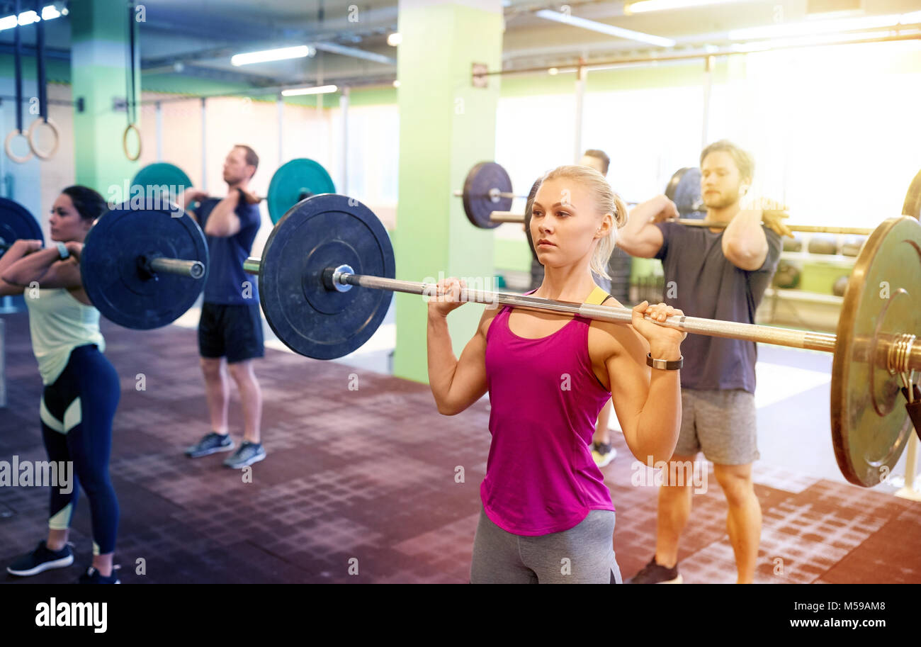 group of people training with barbells in gym Stock Photo - Alamy