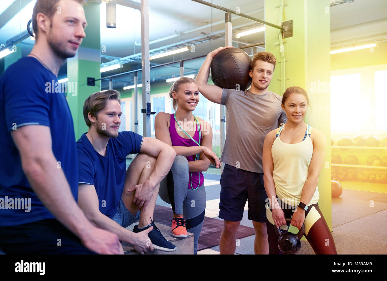 group of friends with sports equipment in gym Stock Photo - Alamy
