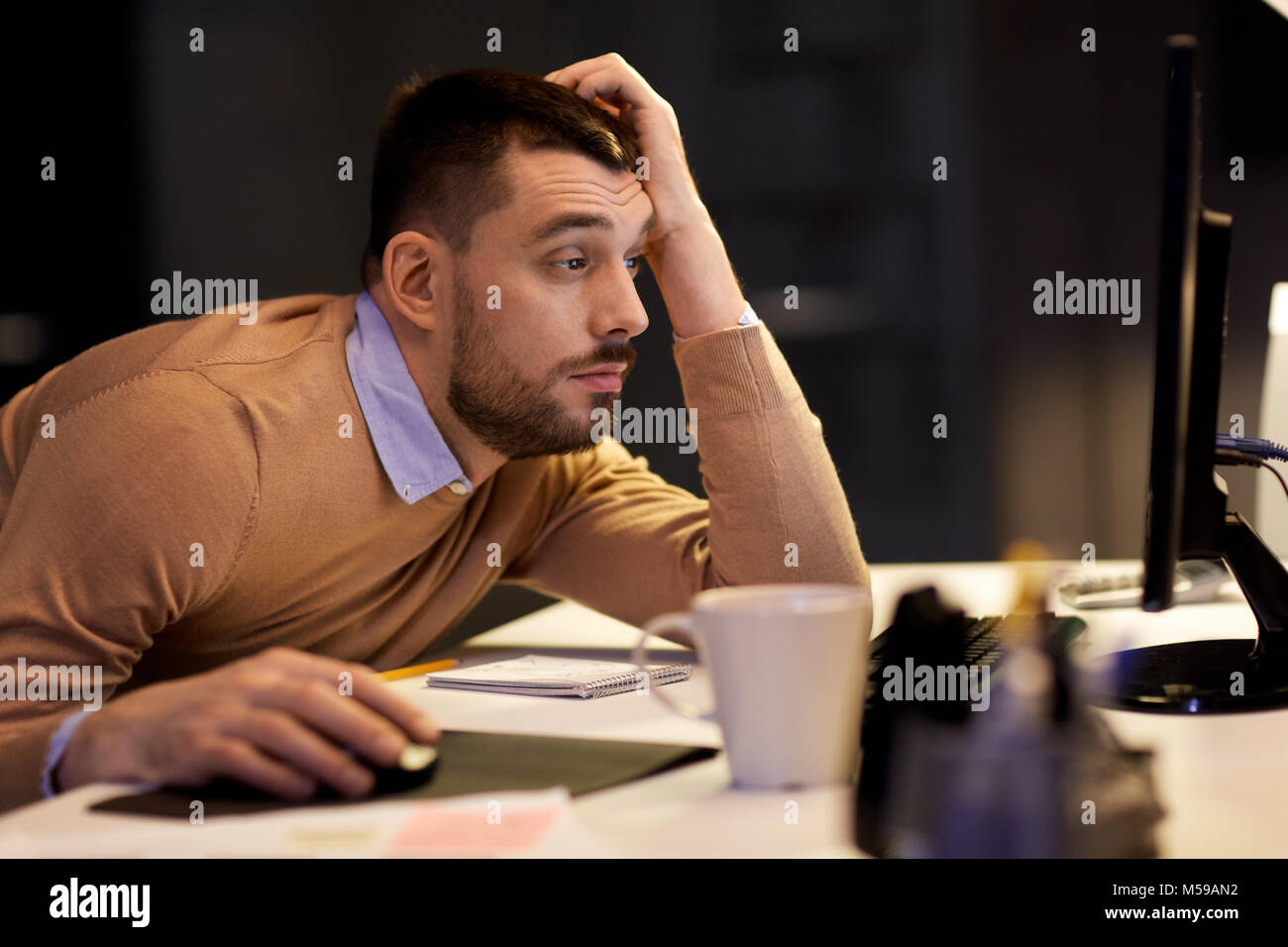 Sleepy man working on computer hi-res stock photography and images - Alamy