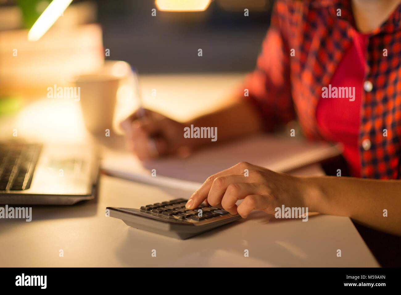 female student hand counting by calculator at home Stock Photo - Alamy
