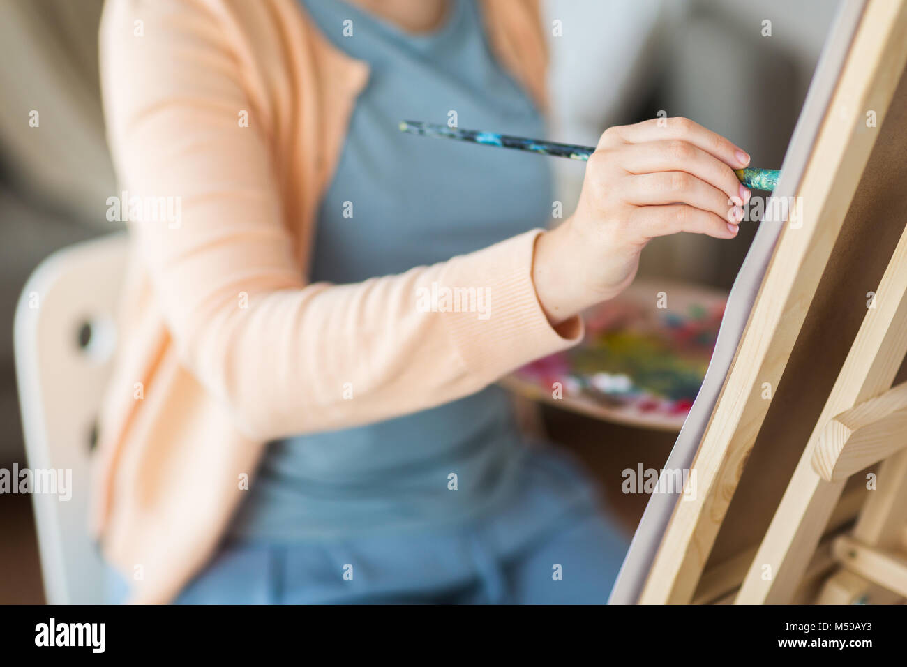artist with brush painting at art studio Stock Photo - Alamy