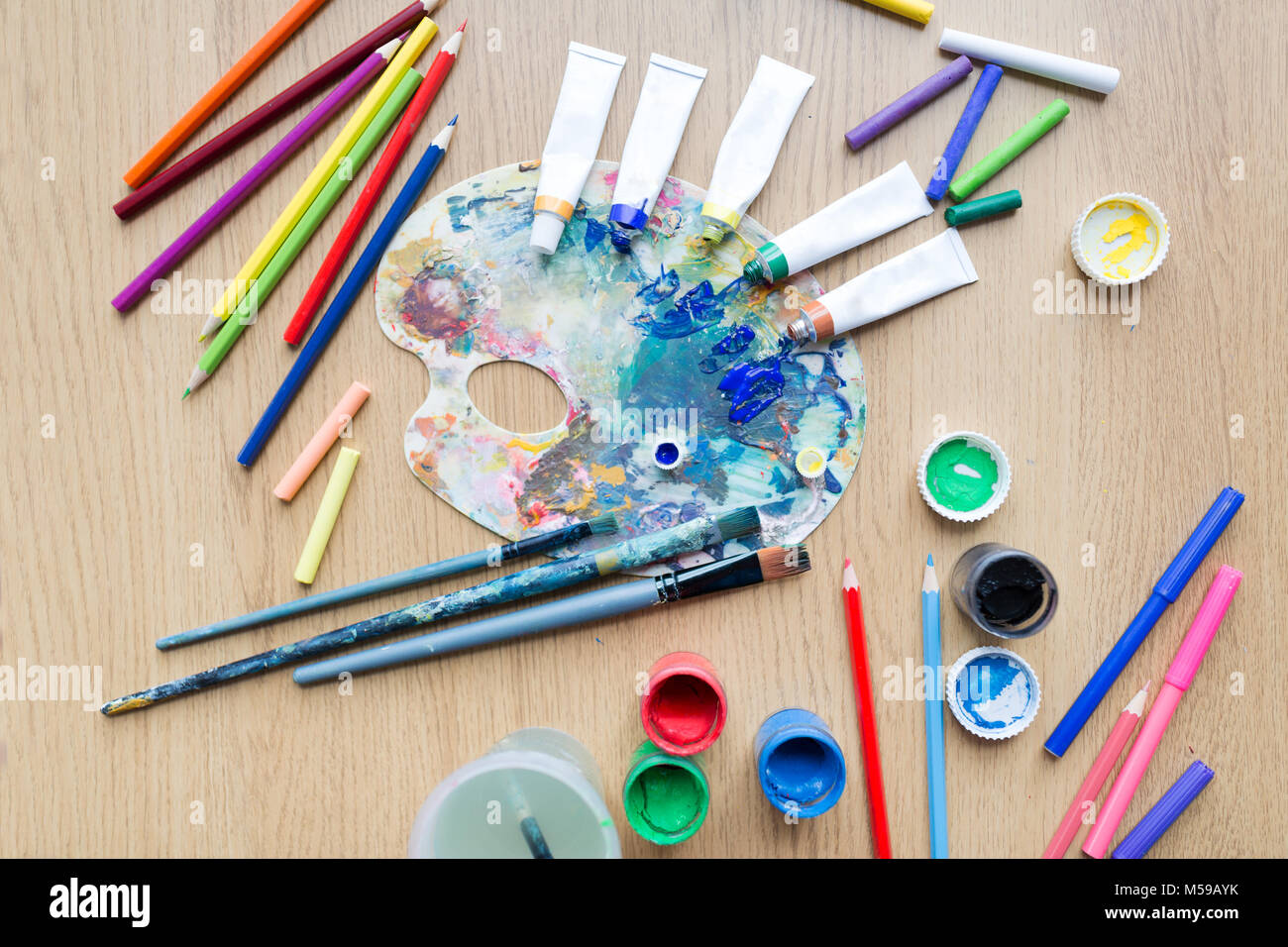 color palette, brushes and paint tubes on table Stock Photo - Alamy