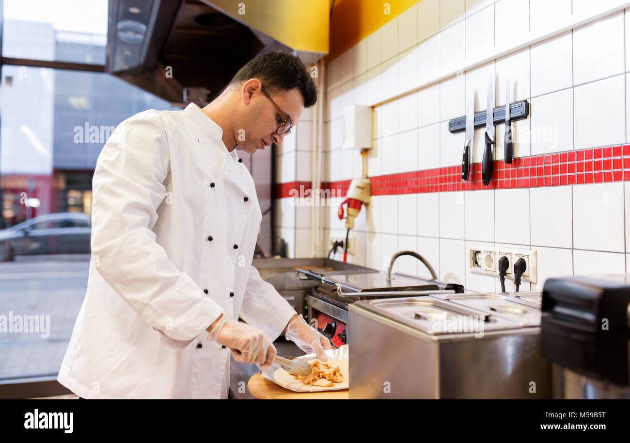 chef making shawarma wrap with meat at kebab shop Stock Photo - Alamy
